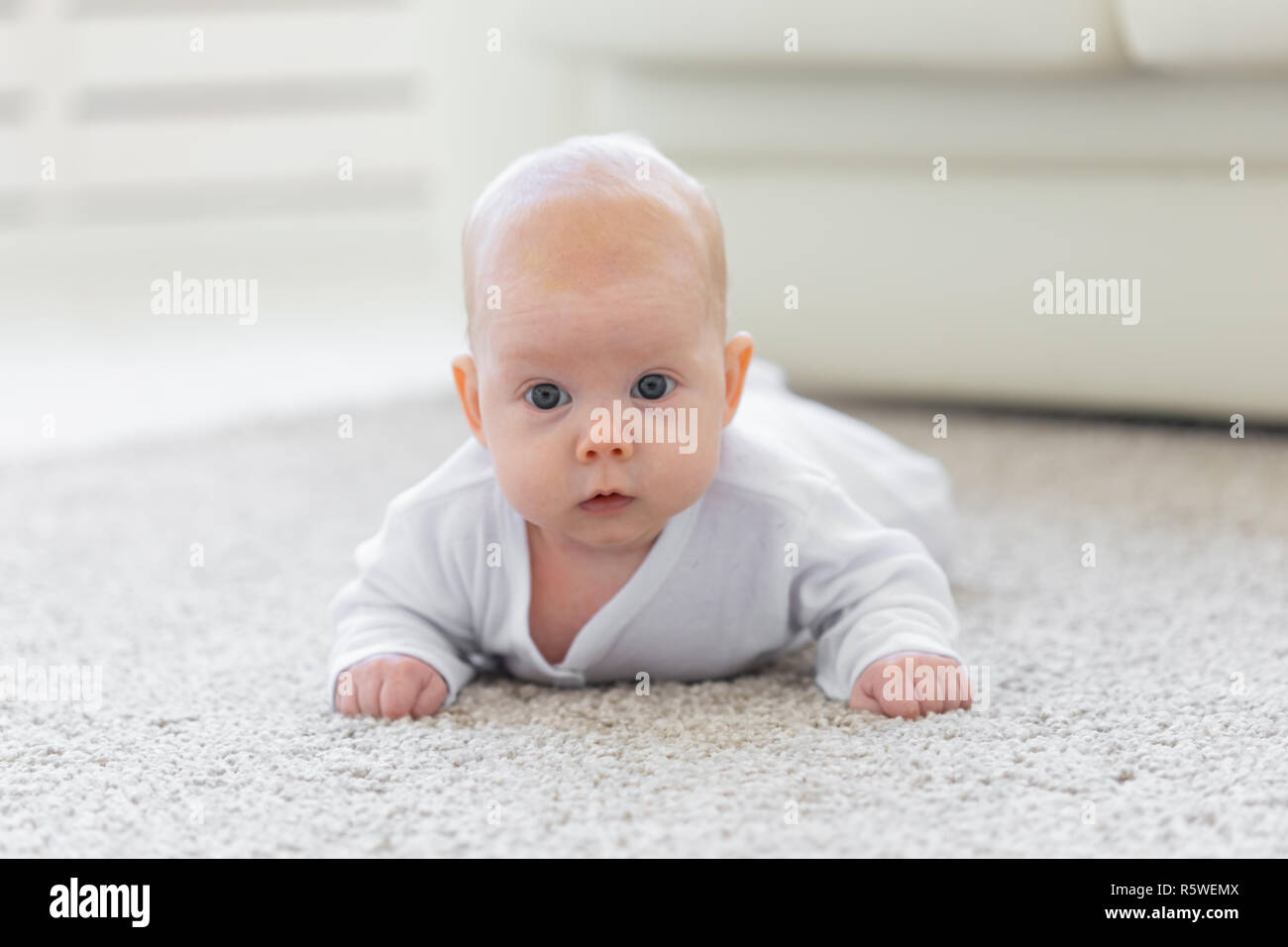Baby, childhood, people concept - Portrait of a crawling baby on the ...