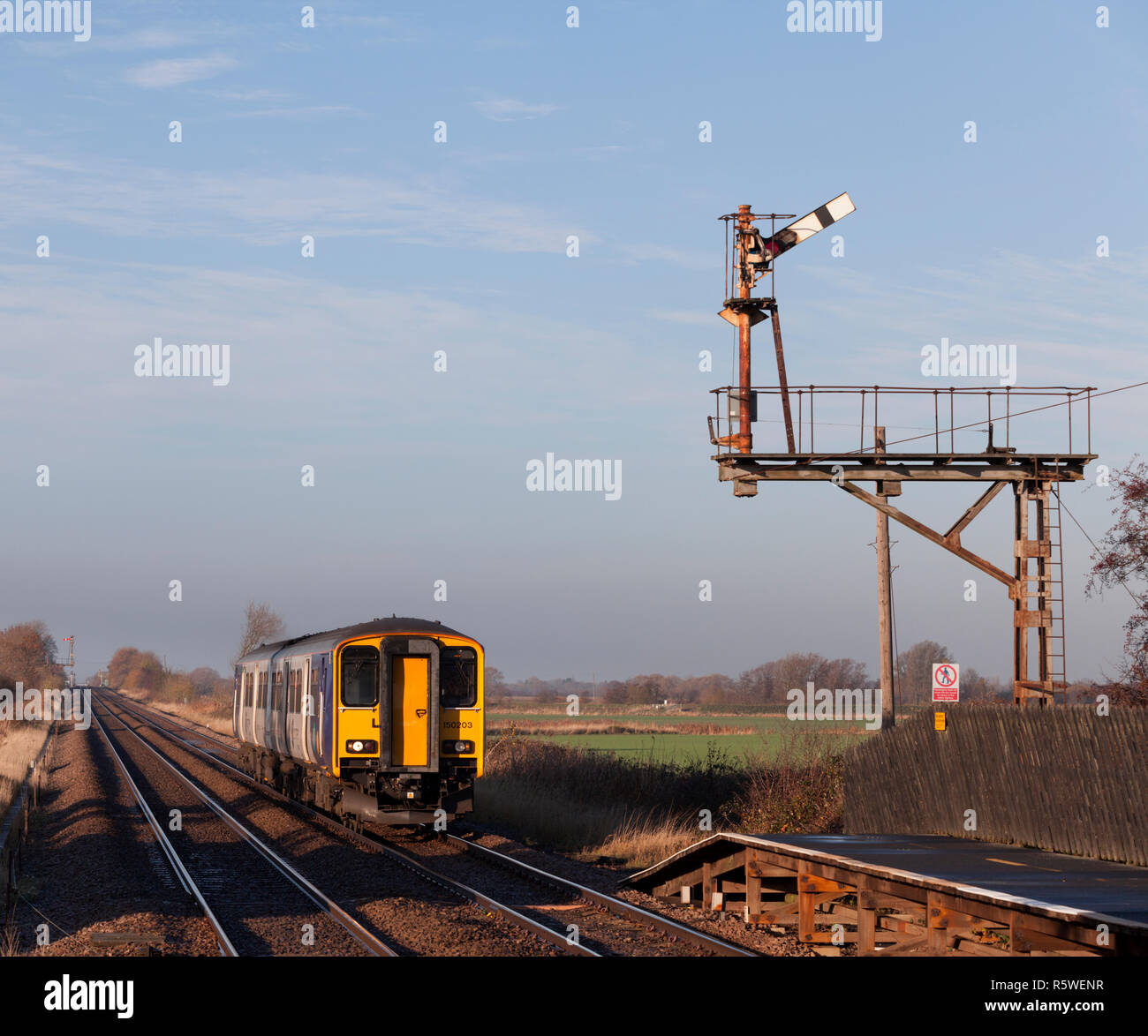 Arriva rail Northern class 150 sprinter train passing the semaphore bracket signals at ...