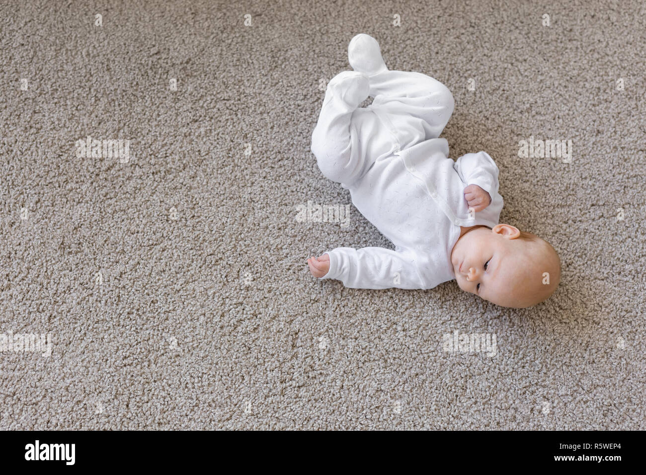 Childhood, infant and people concept - baby lies on his back on the ...