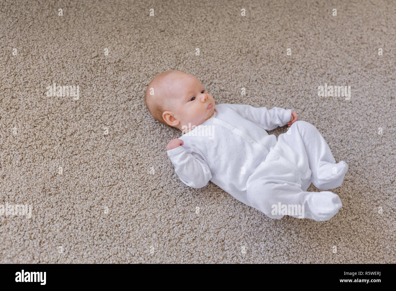 Baby, infant and childhood concept - Top view of the child on the floor ...