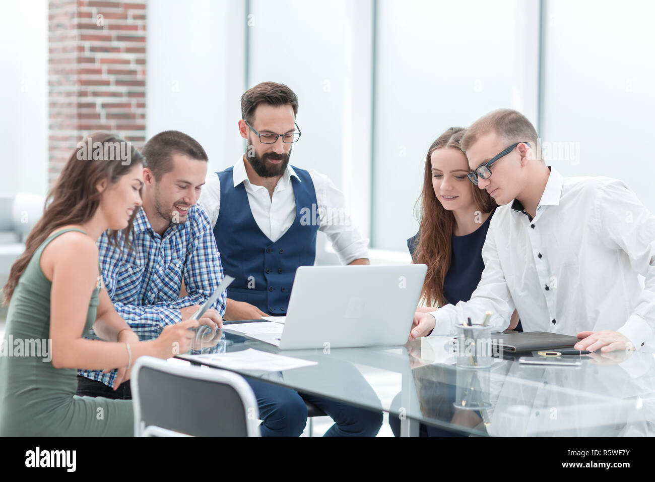 smiling business team looking at laptop screen Stock Photo - Alamy