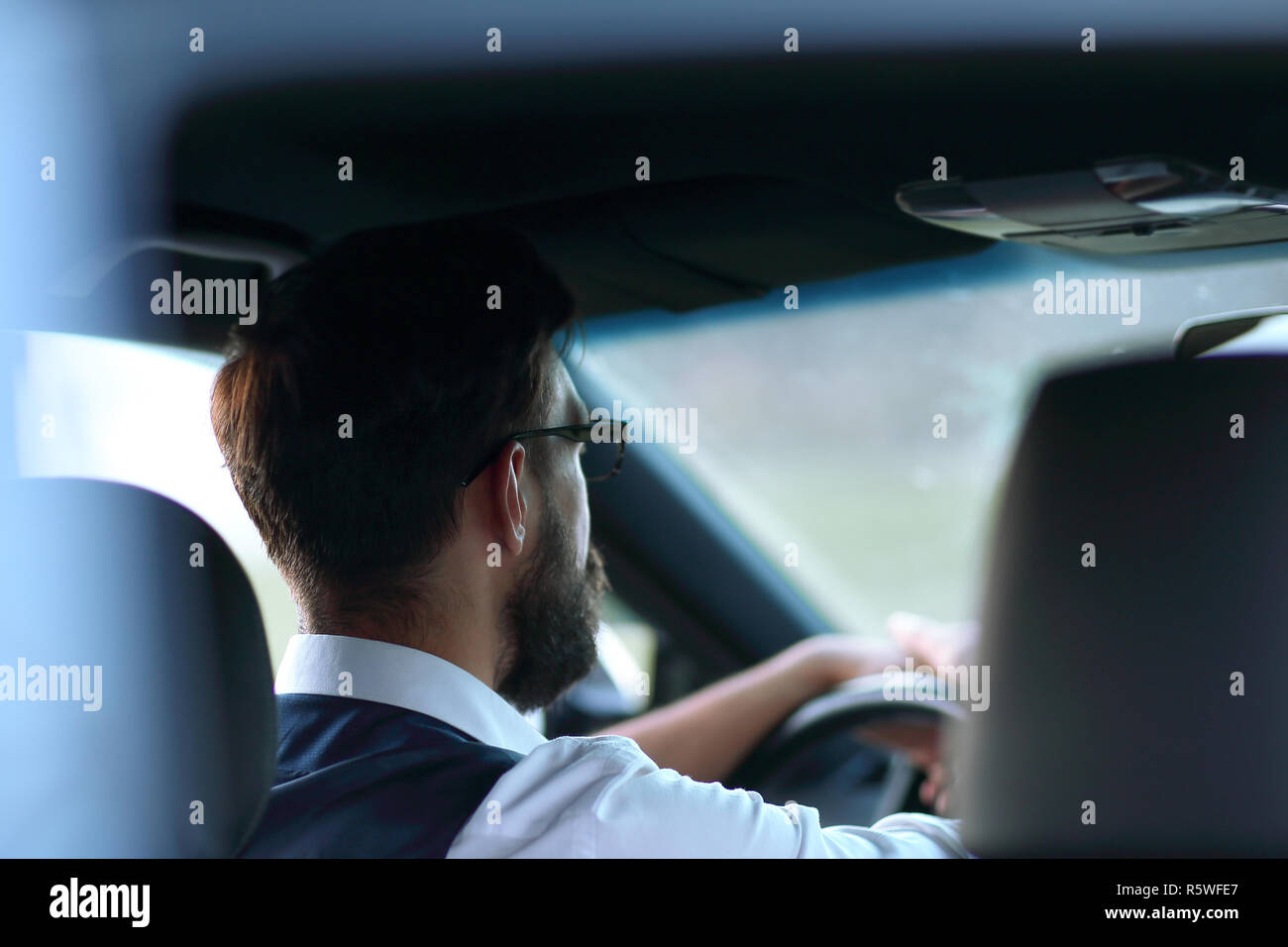 rear view.business man sitting in a modern car Stock Photo - Alamy