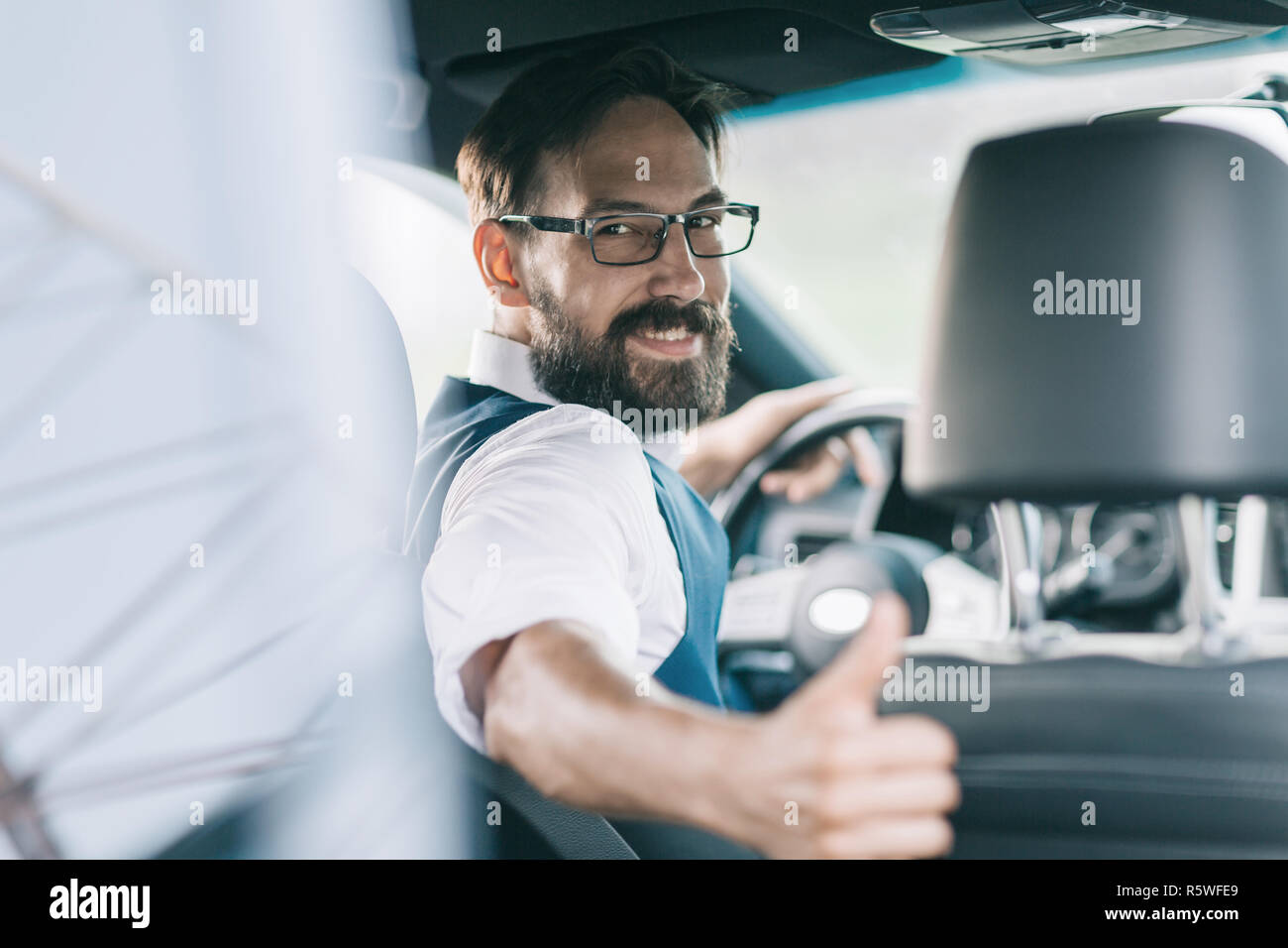 rear view.business man sitting behind the wheel of a car Stock Photo ...