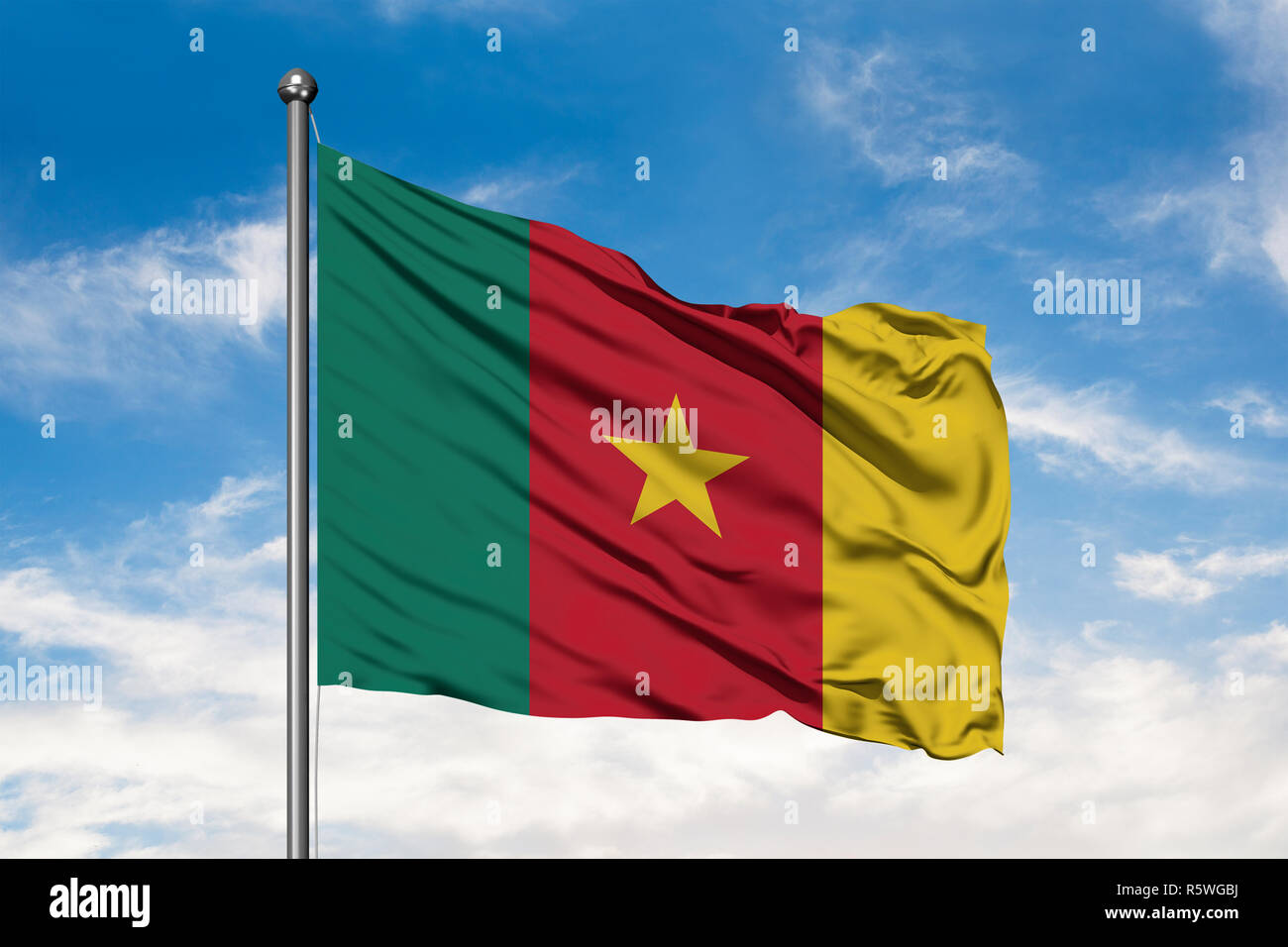 Flag of Cameroon waving in the wind against white cloudy blue sky ...