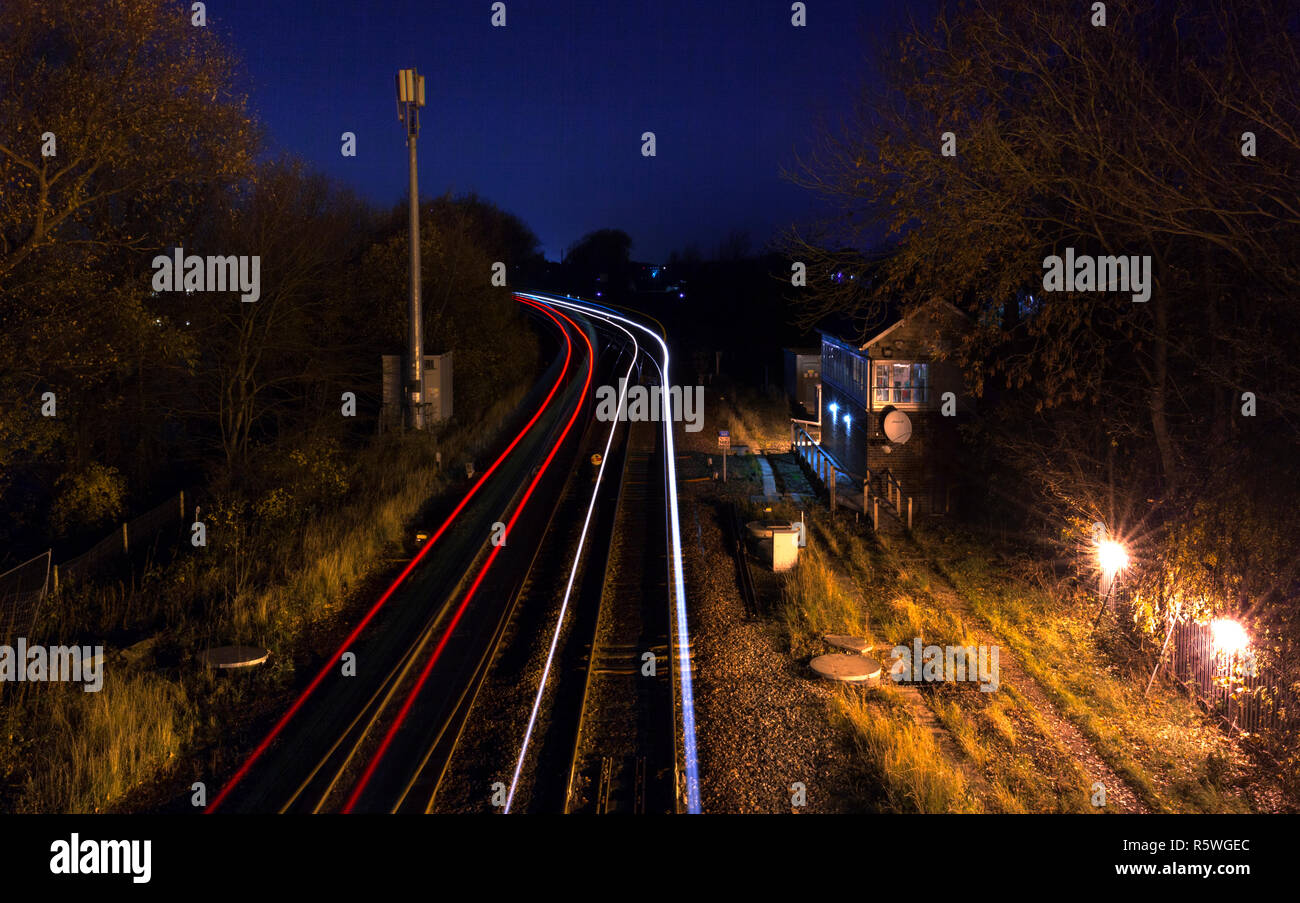 Red and white light trails at night from passing trains at Gilberdyke ...