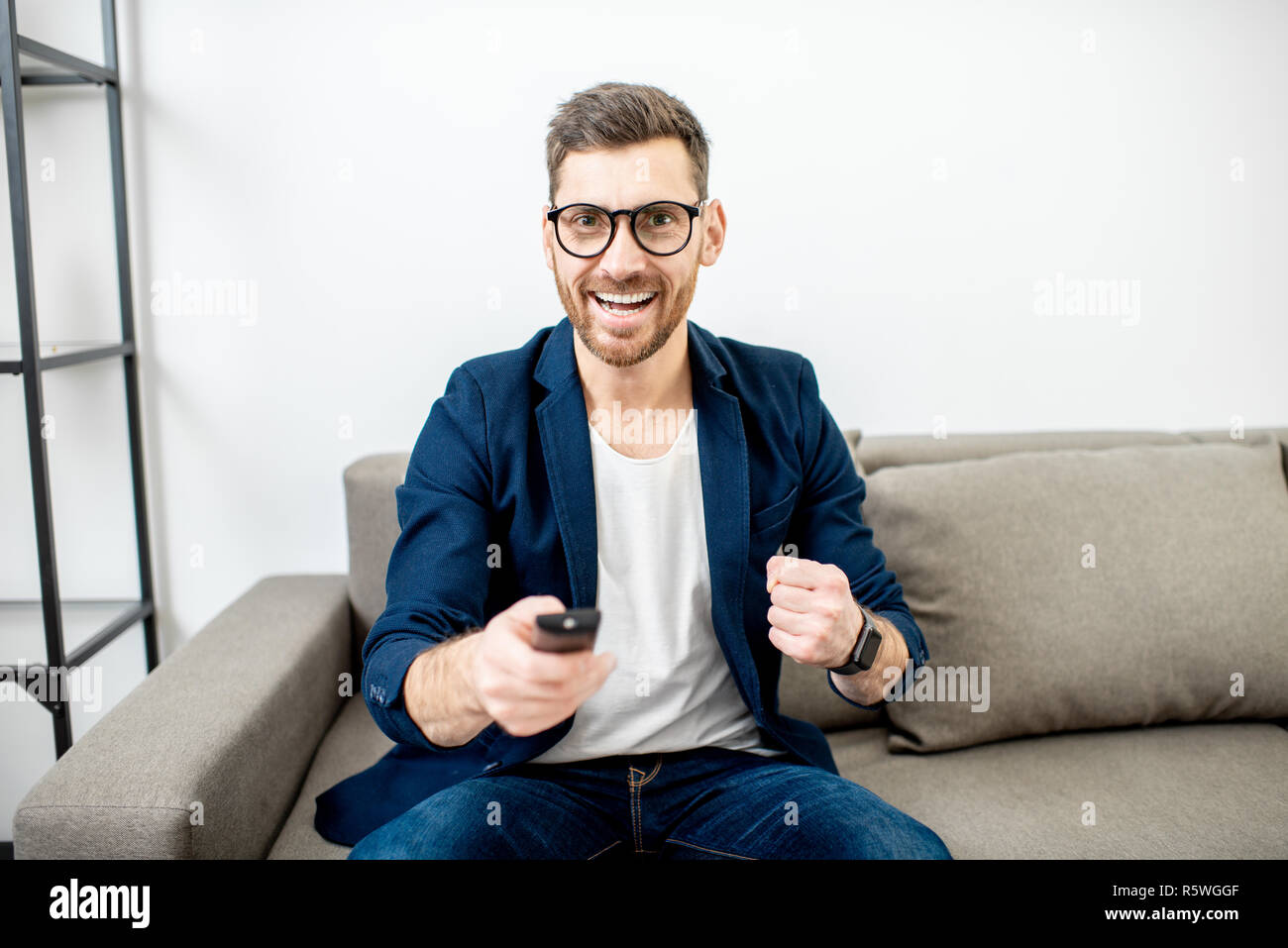 Man cheering for a game on tv hi-res stock photography and images - Alamy