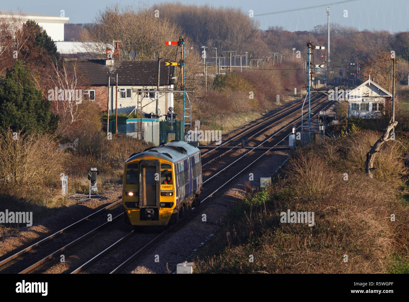 Arriva Northern Rail class 158 sprinter train passing the mechanical signal box and semaphore ...