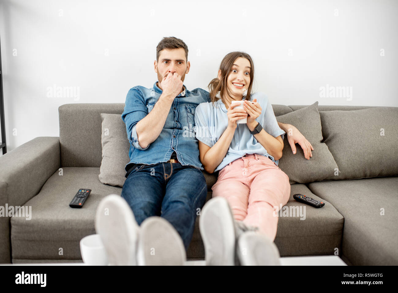 Family sitting on couch watching tv hi-res stock photography and images ...