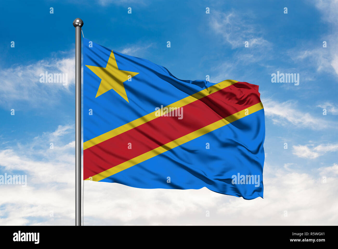 Flag of Congo waving in the wind against white cloudy blue sky ...