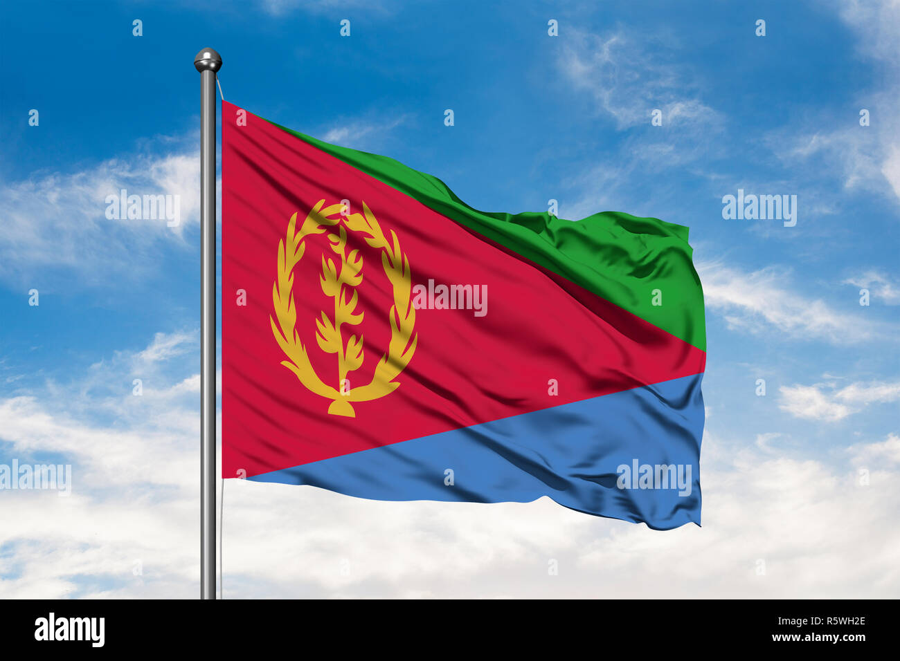 Flag of Eritrea waving in the wind against white cloudy blue sky ...