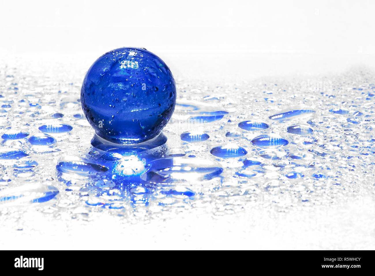 Blue Marble on a wet table Stock Photo - Alamy