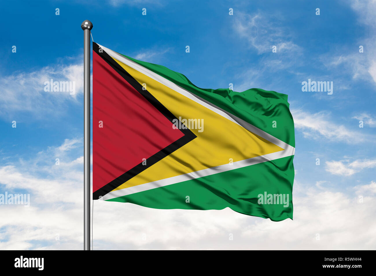 Flag of Guyana waving in the wind against white cloudy blue sky. Guyanese flag Stock Photo - Alamy