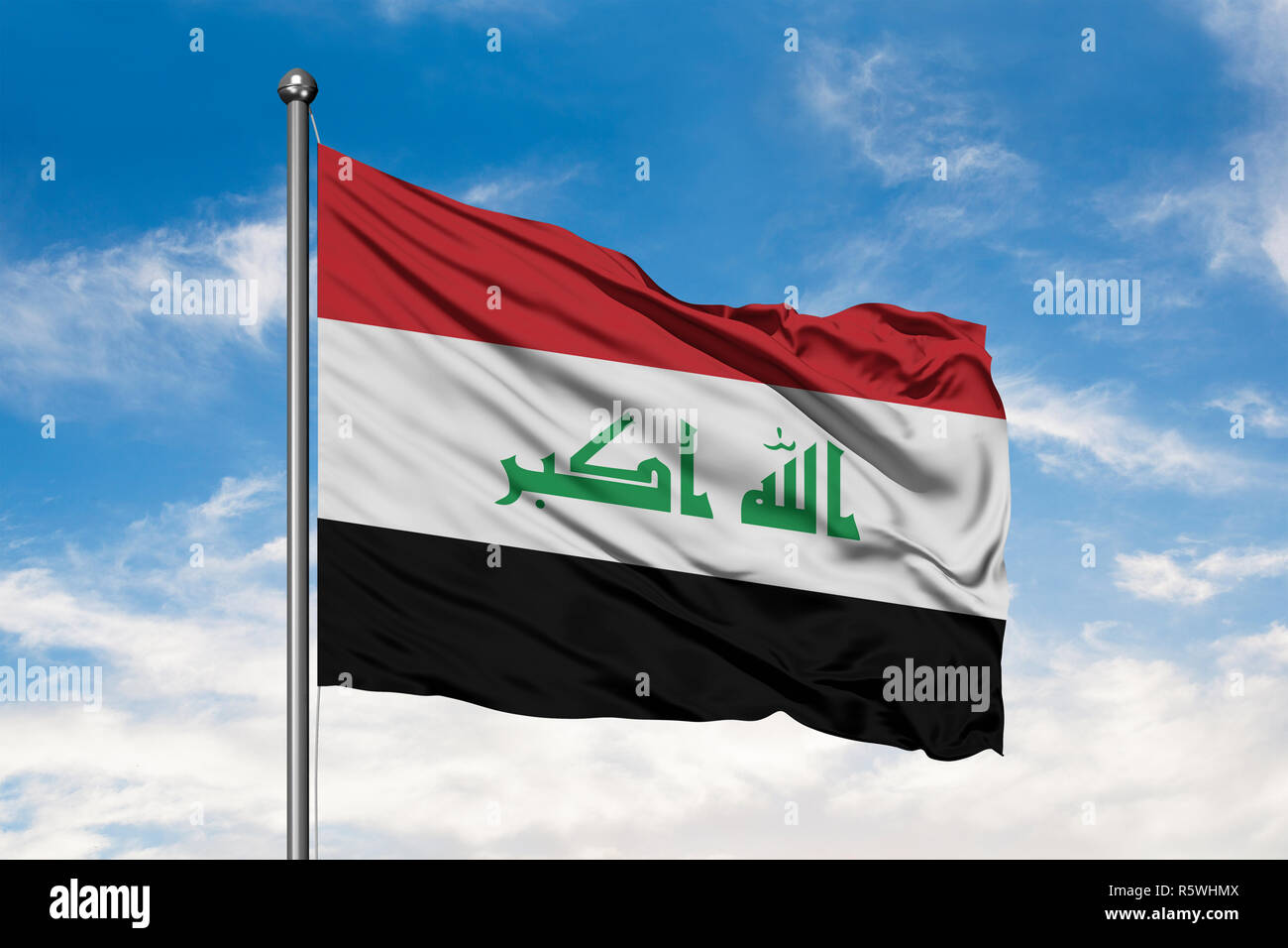 Flag of Iraq waving in the wind against white cloudy blue sky. Iraqi ...