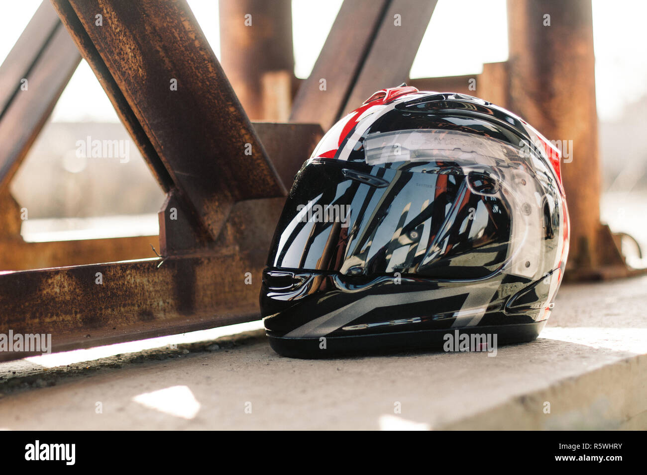 Modern motorcycle helmet on urban bright background Stock Photo - Alamy