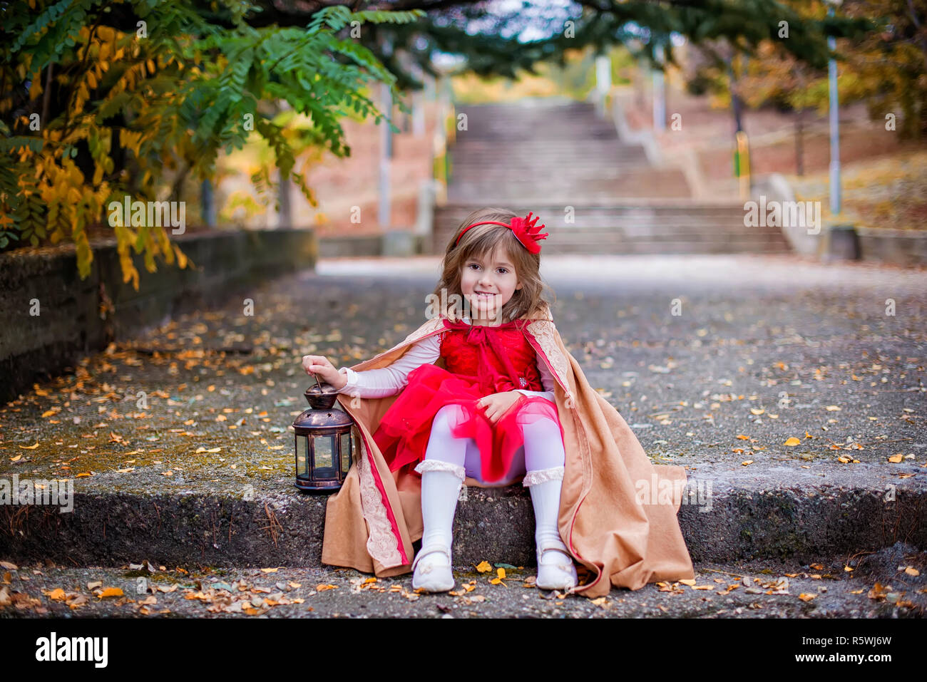 Girl sitting on a step wearing a fancy dress princess costume, Bulgaria ...