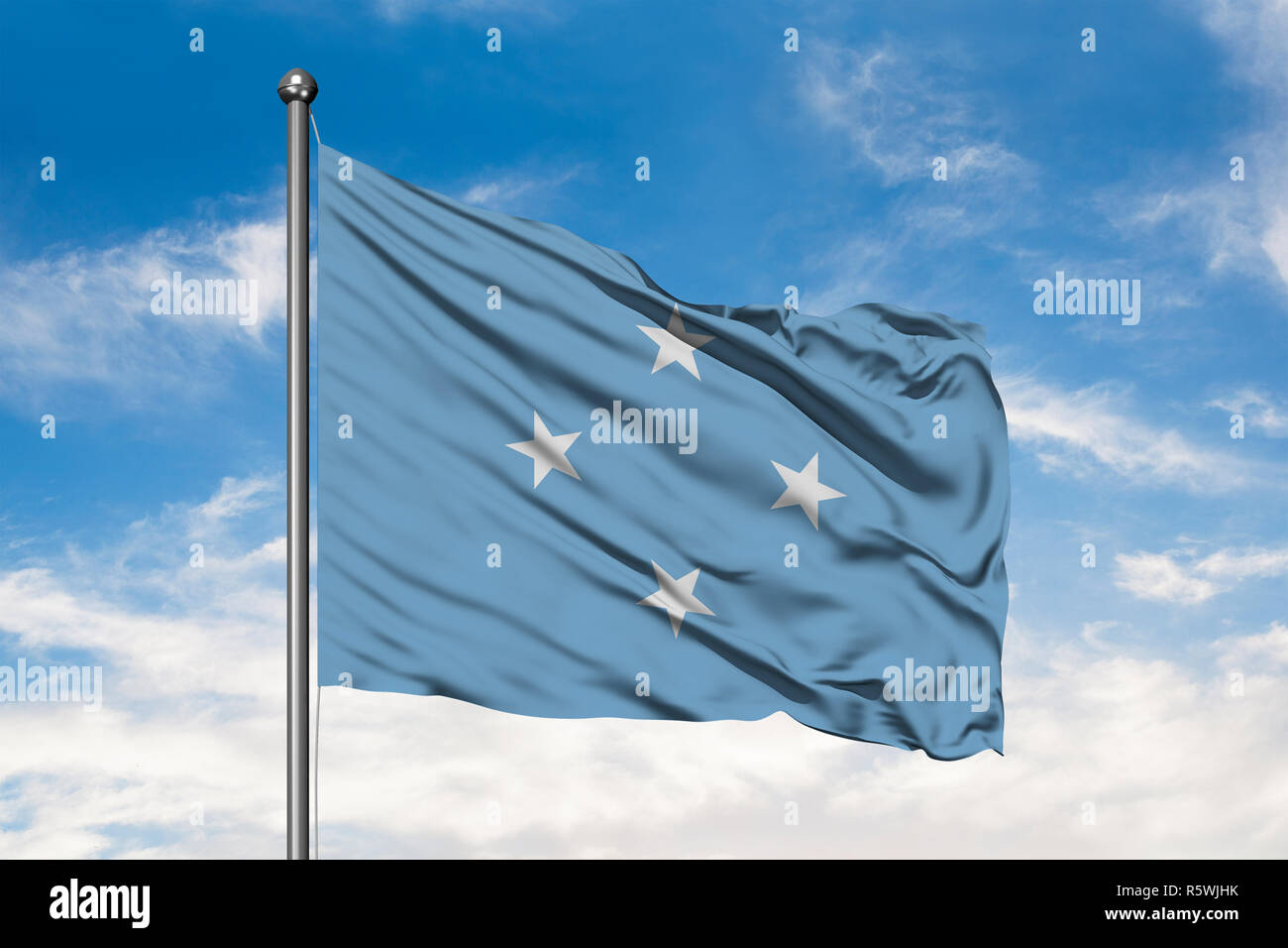 Flag of Micronesia waving in the wind against white cloudy blue sky ...