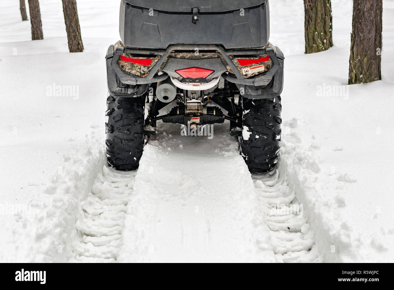 Tail of ATV 4wd quad bike in forest at winter. 4wd all-terreain vehicle ...