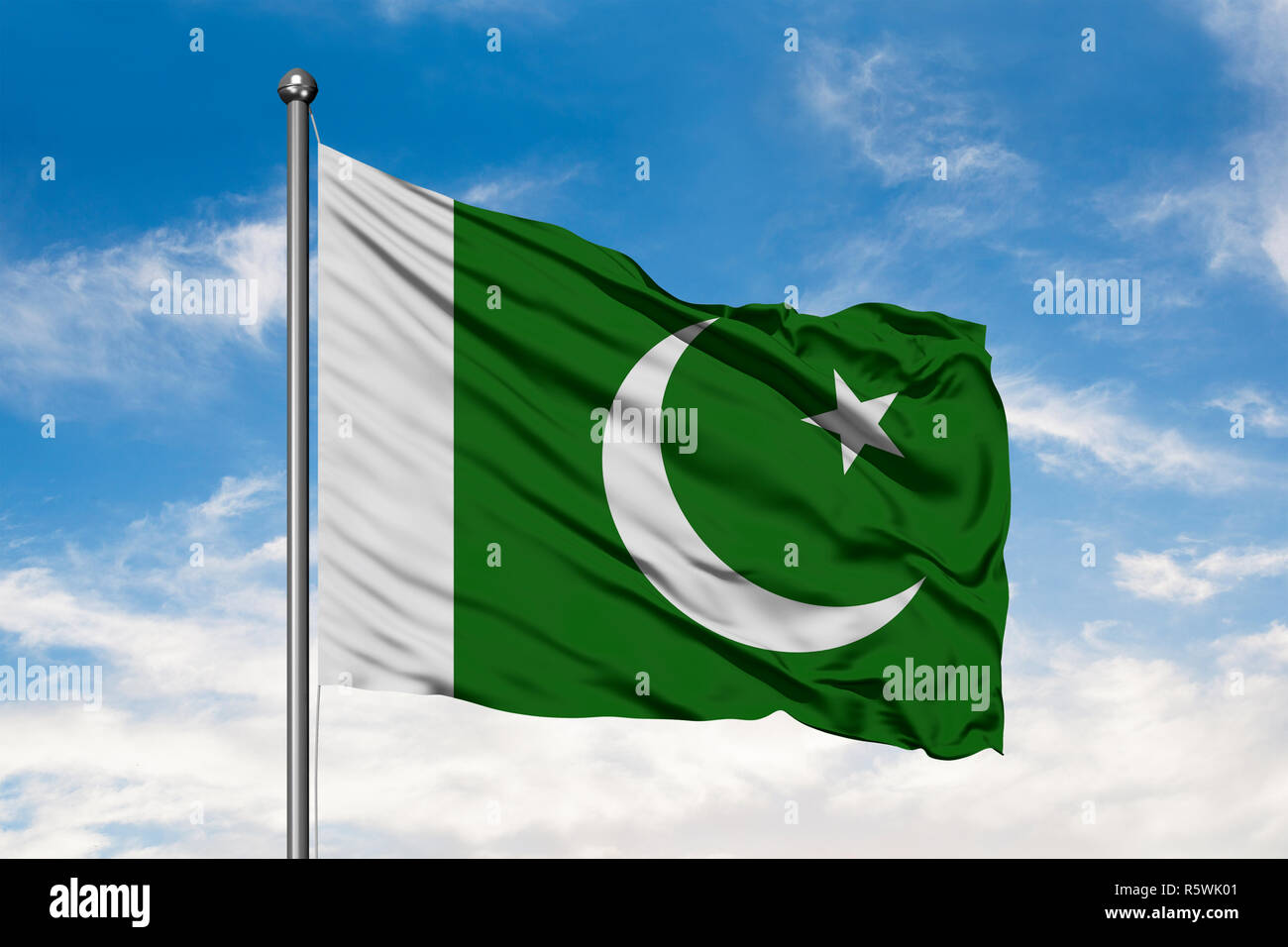Flag of Pakistan waving in the wind against white cloudy blue sky ...