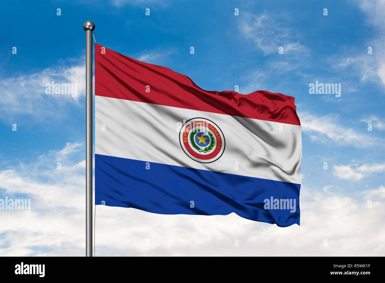 Flag of Paraguay waving in the wind against white cloudy blue sky ...