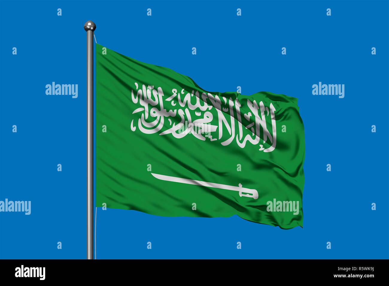 Flag of Saudi Arabia waving in the wind against deep blue sky. Arabian ...
