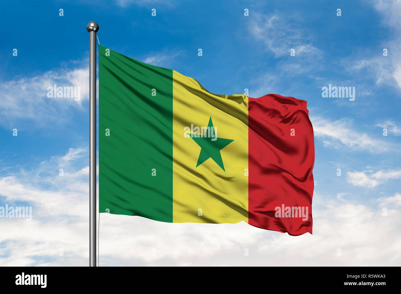 Flag of Senegal waving in the wind against white cloudy blue sky ...