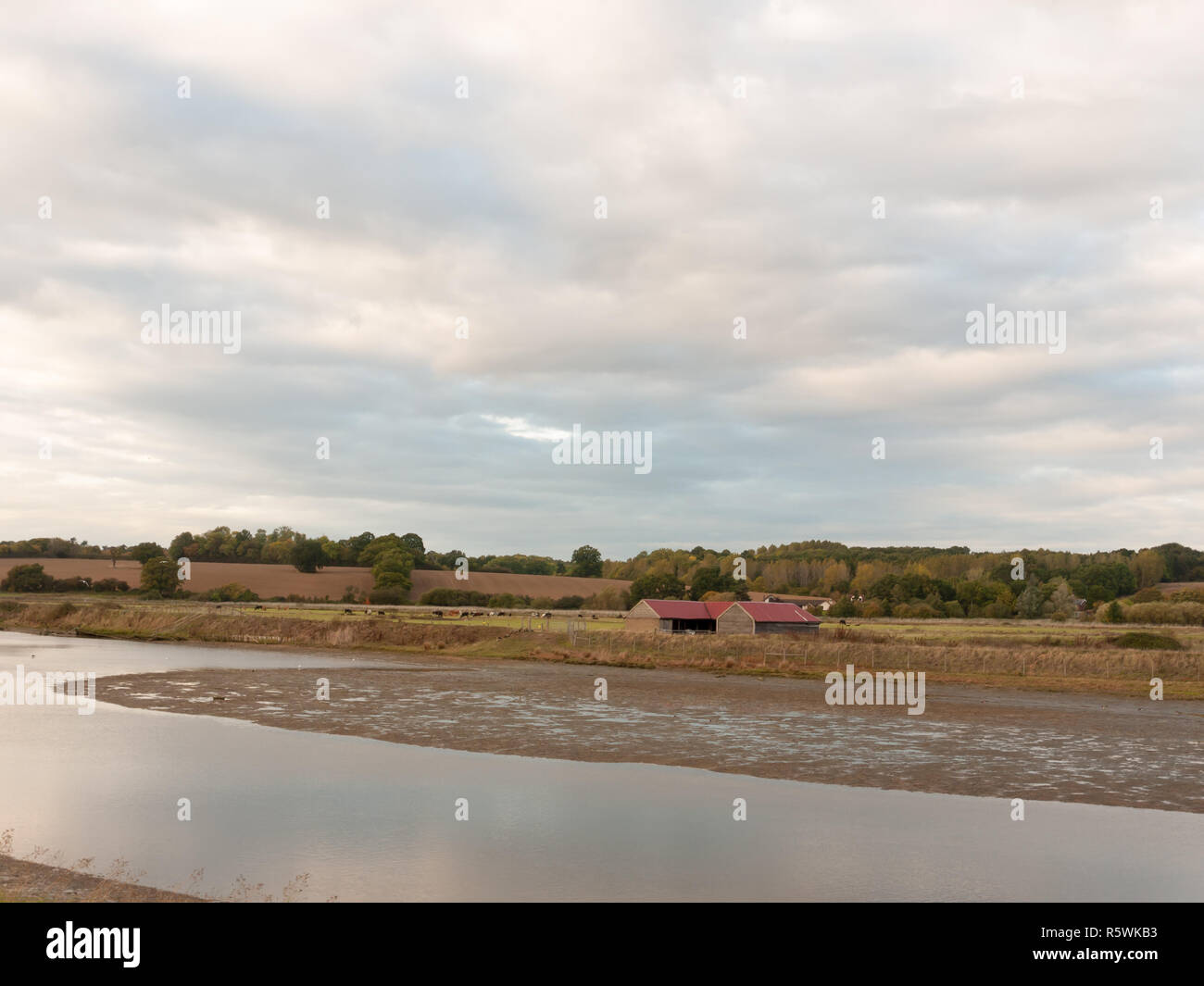 lake river through countryside with farm house roof agriculture scene ...