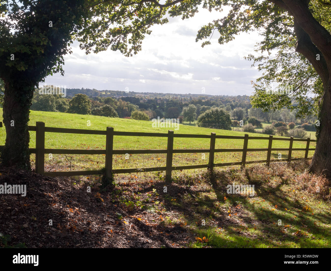 country side open rolling fields below with wooden fence up front Stock ...