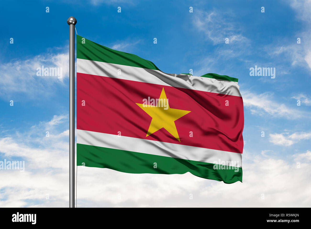 Flag of Suriname waving in the wind against white cloudy blue sky ...