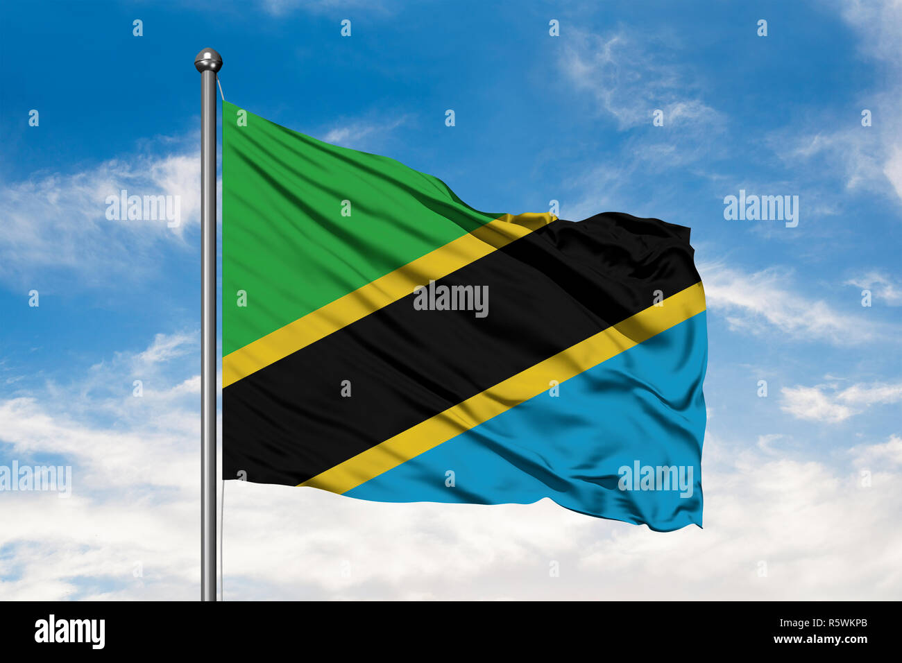 Flag of Tanzania waving in the wind against white cloudy blue sky ...