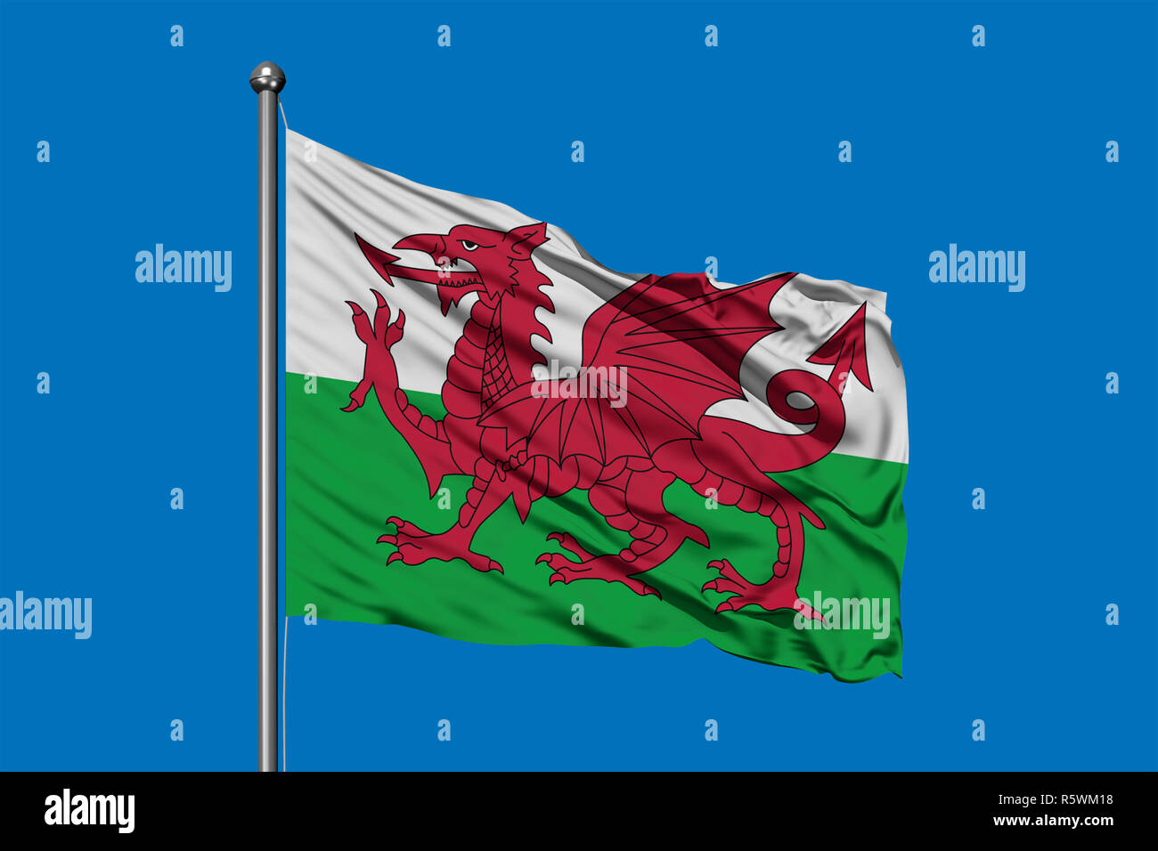 Flag of Wales waving in the wind against deep blue sky. Welsh flag ...