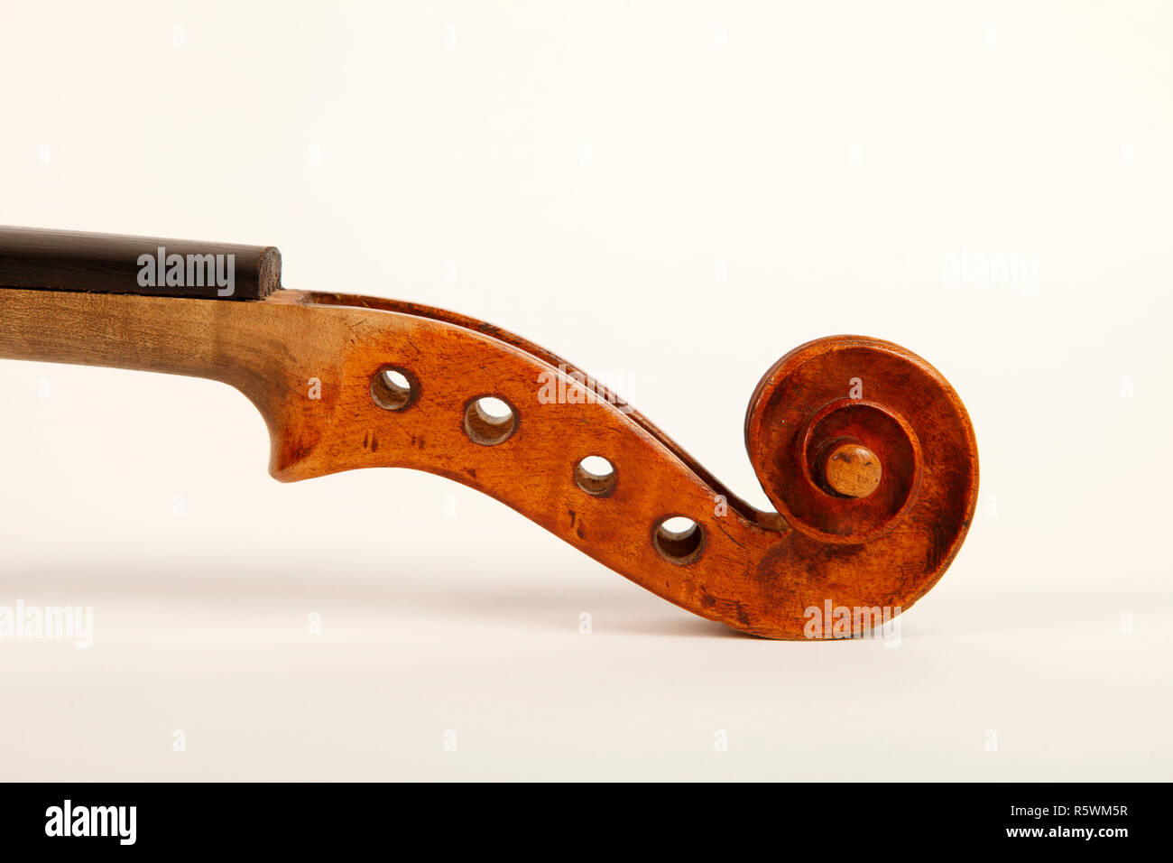 Old violin scroll showing the peg holes Stock Photo - Alamy