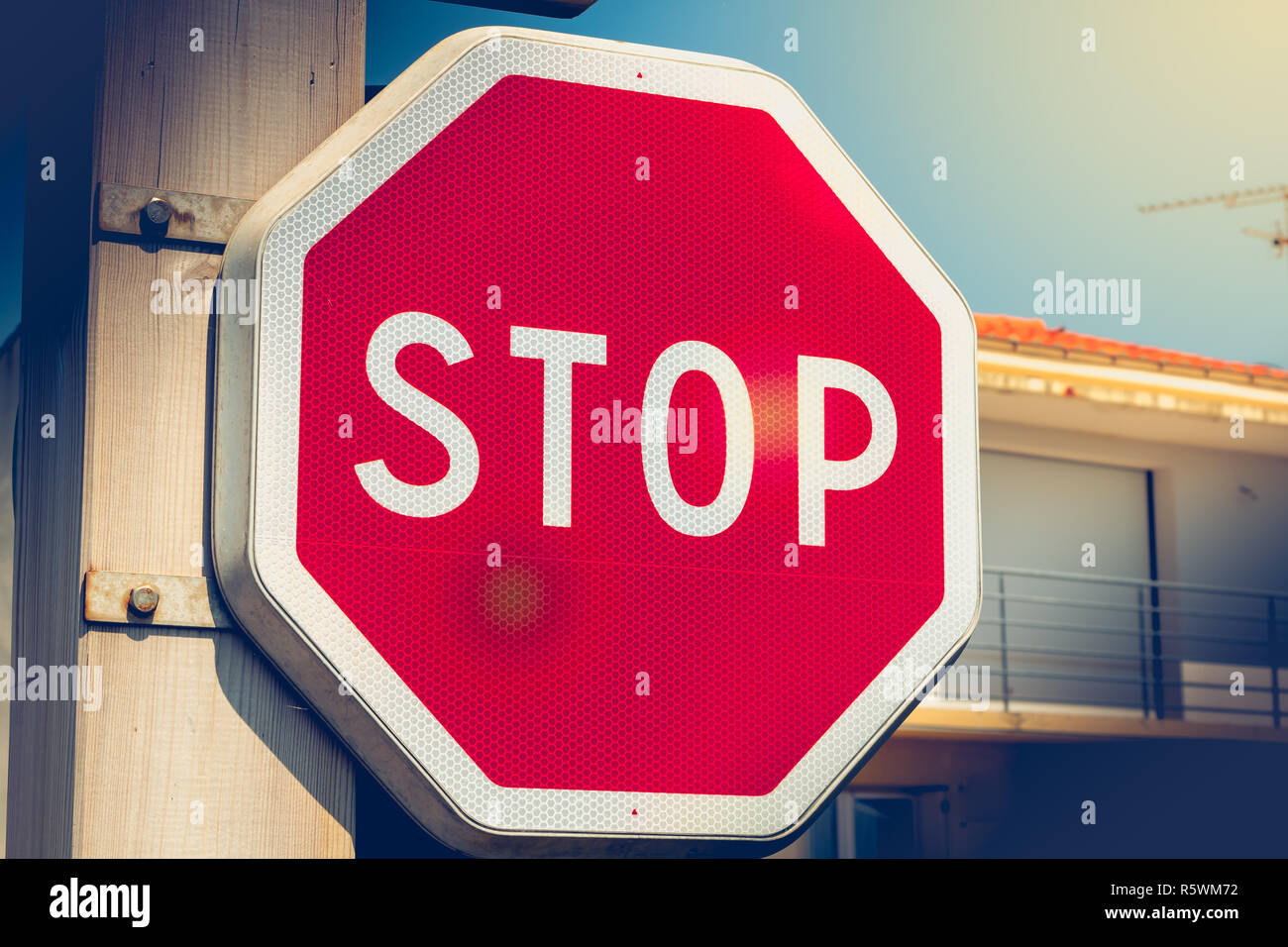red sign STOP at the exit of a parking lot Stock Photo - Alamy