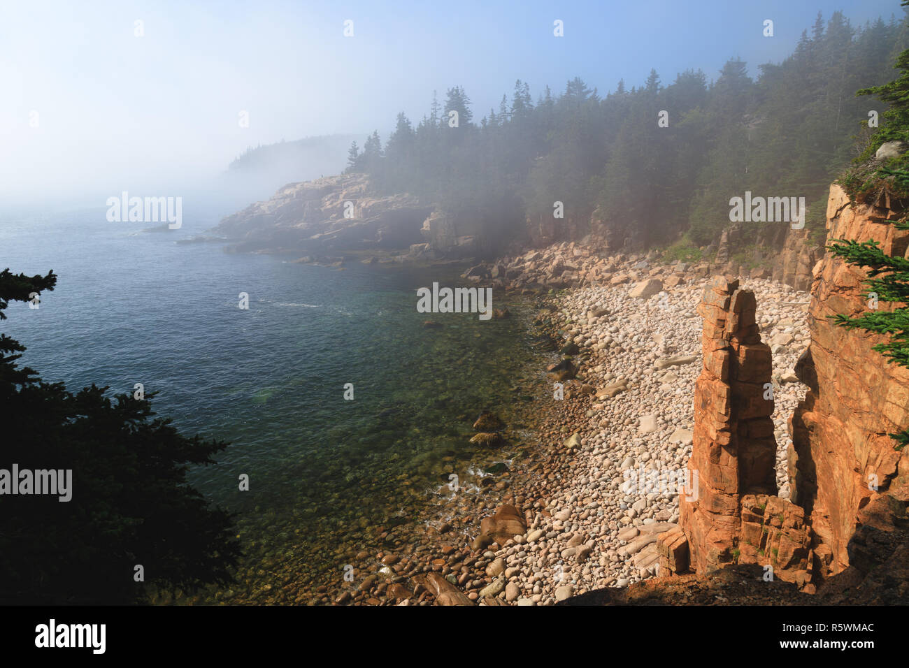 Misty sunrise along the coastline at Monument Cove in Acadia National ...