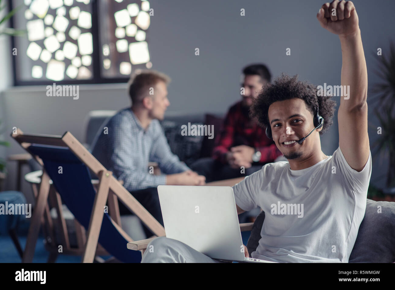 Laughing african american hipster software developer at computer at ...