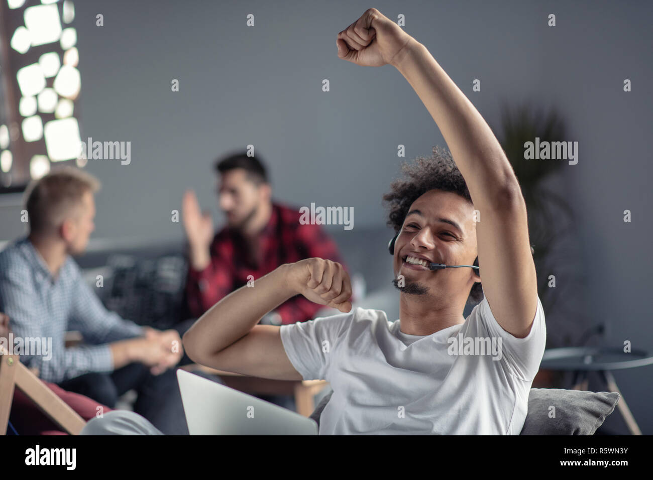 Laughing african american hipster software developer at computer at ...