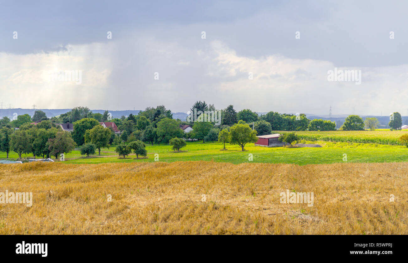 rainy scenery with small village Stock Photo - Alamy