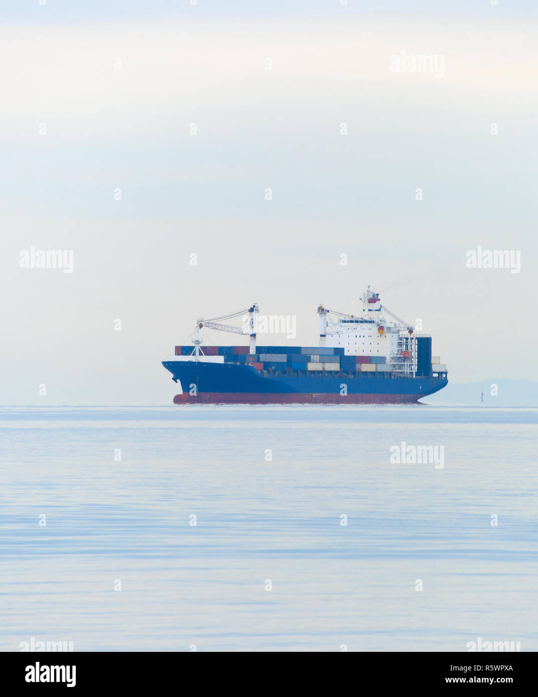 Cargo ship sailing far hi-res stock photography and images - Alamy