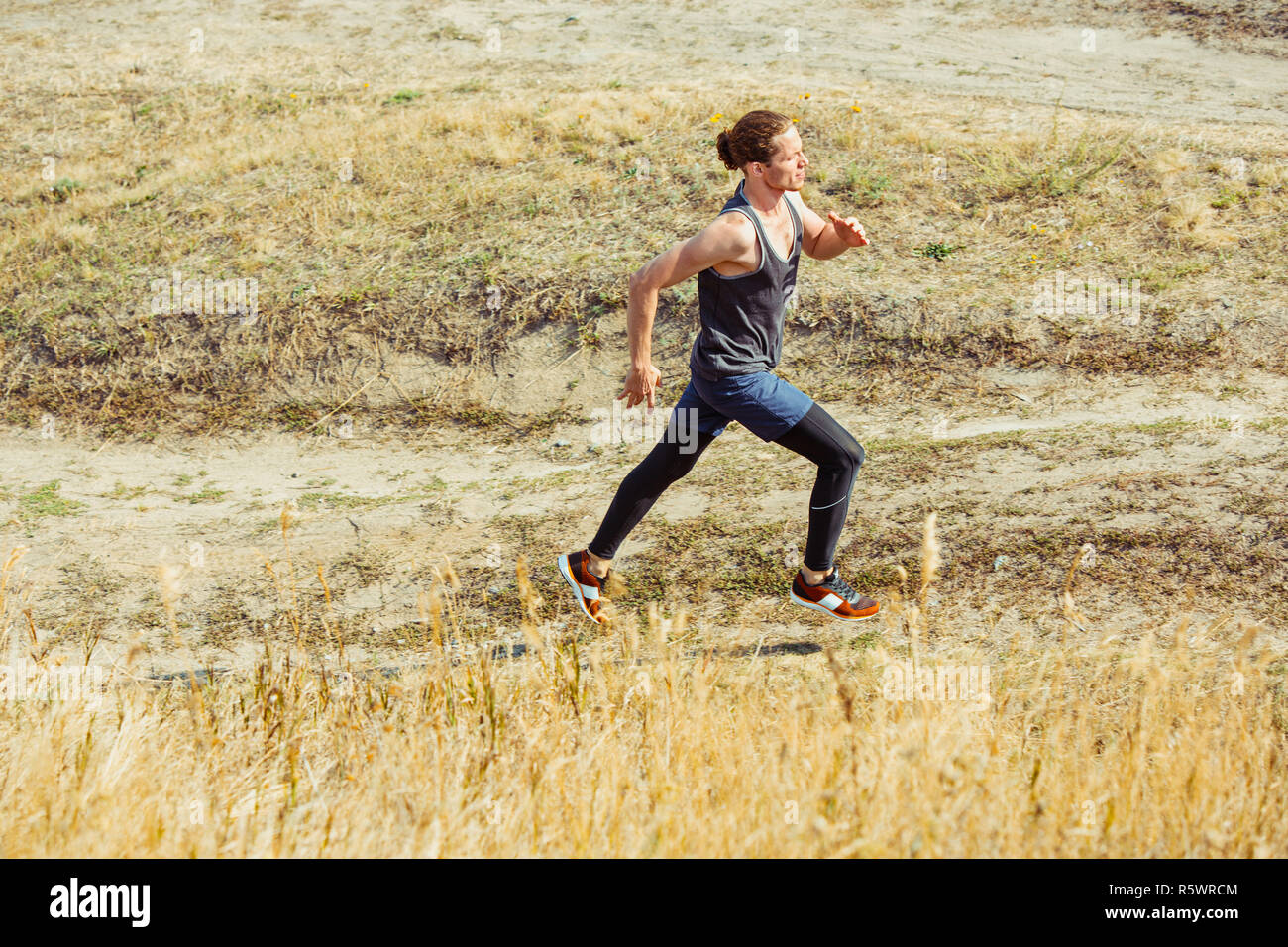 Running sport. Man runner sprinting outdoor in scenic nature. Fit ...