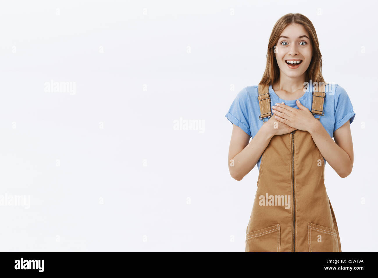 Portrait of delighted greatful charming kind young girl in brown ...