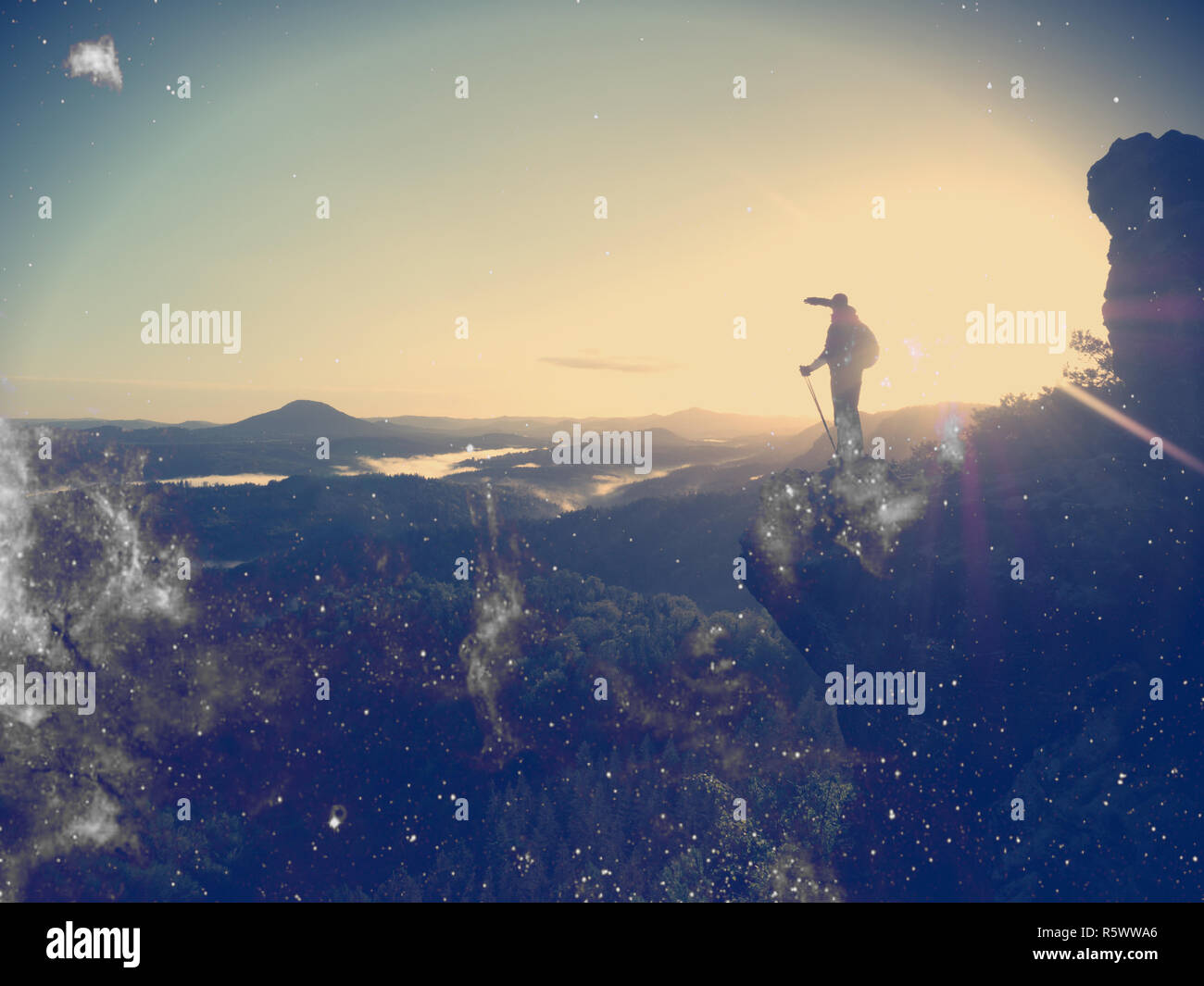 Abstract, over filtered. Man walking on the edge of sharp cliff high ...