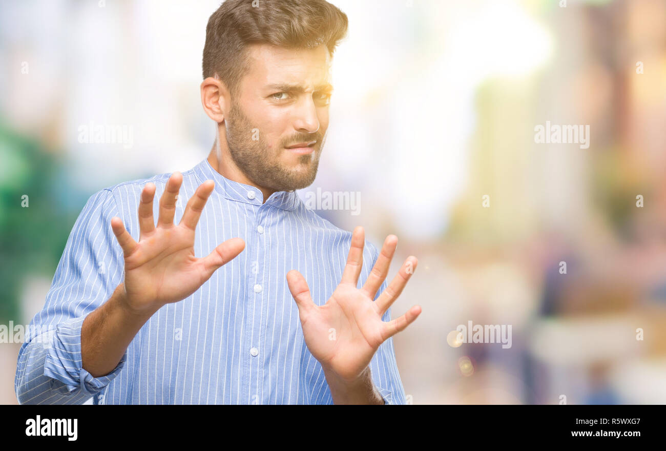 Young handsome man over isolated background disgusted expression ...