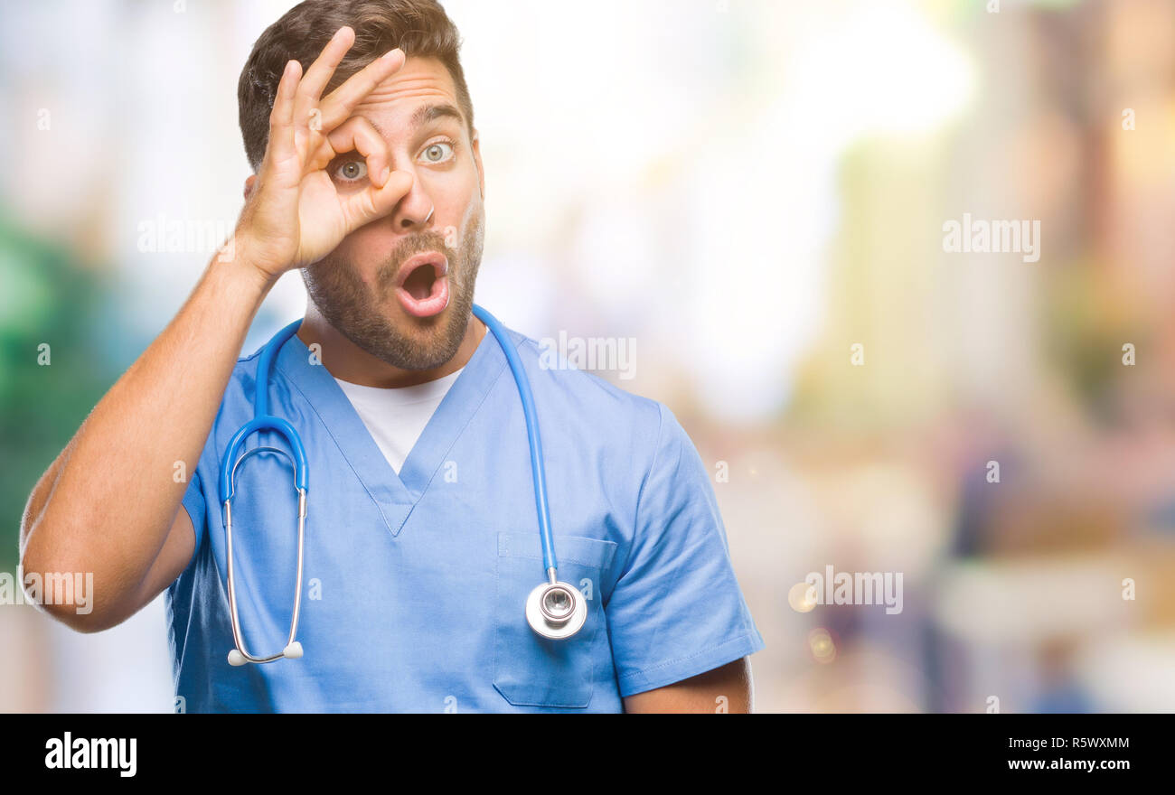 Young handsome doctor surgeon man over isolated background doing ok ...