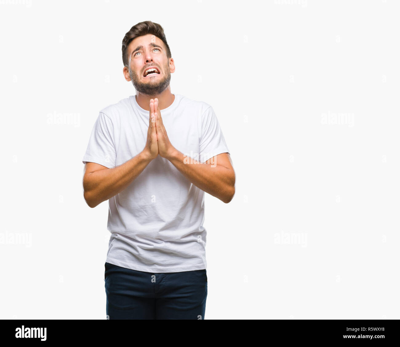 Young handsome man over isolated background begging and praying with ...