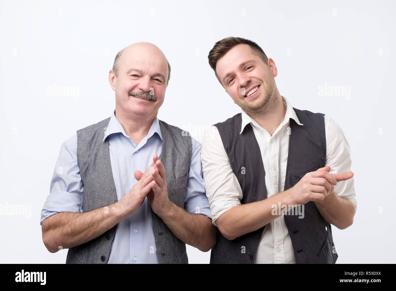 Happy handsome men applauding, clapping hands and looking away Stock ...