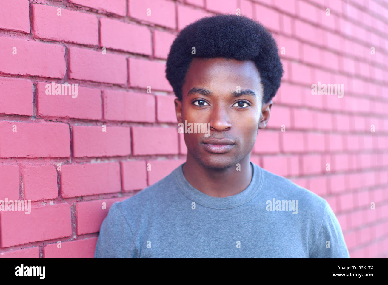 young african male man outside portrait brick wall Stock Photo - Alamy