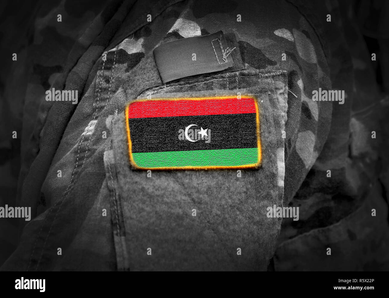 Flag of Libya on soldiers arm (collage Stock Photo - Alamy