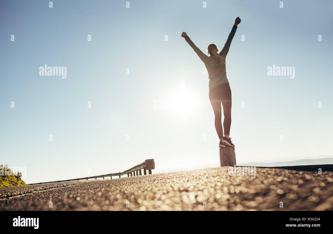 Woman arms raised rear view sky hi-res stock photography and images - Alamy