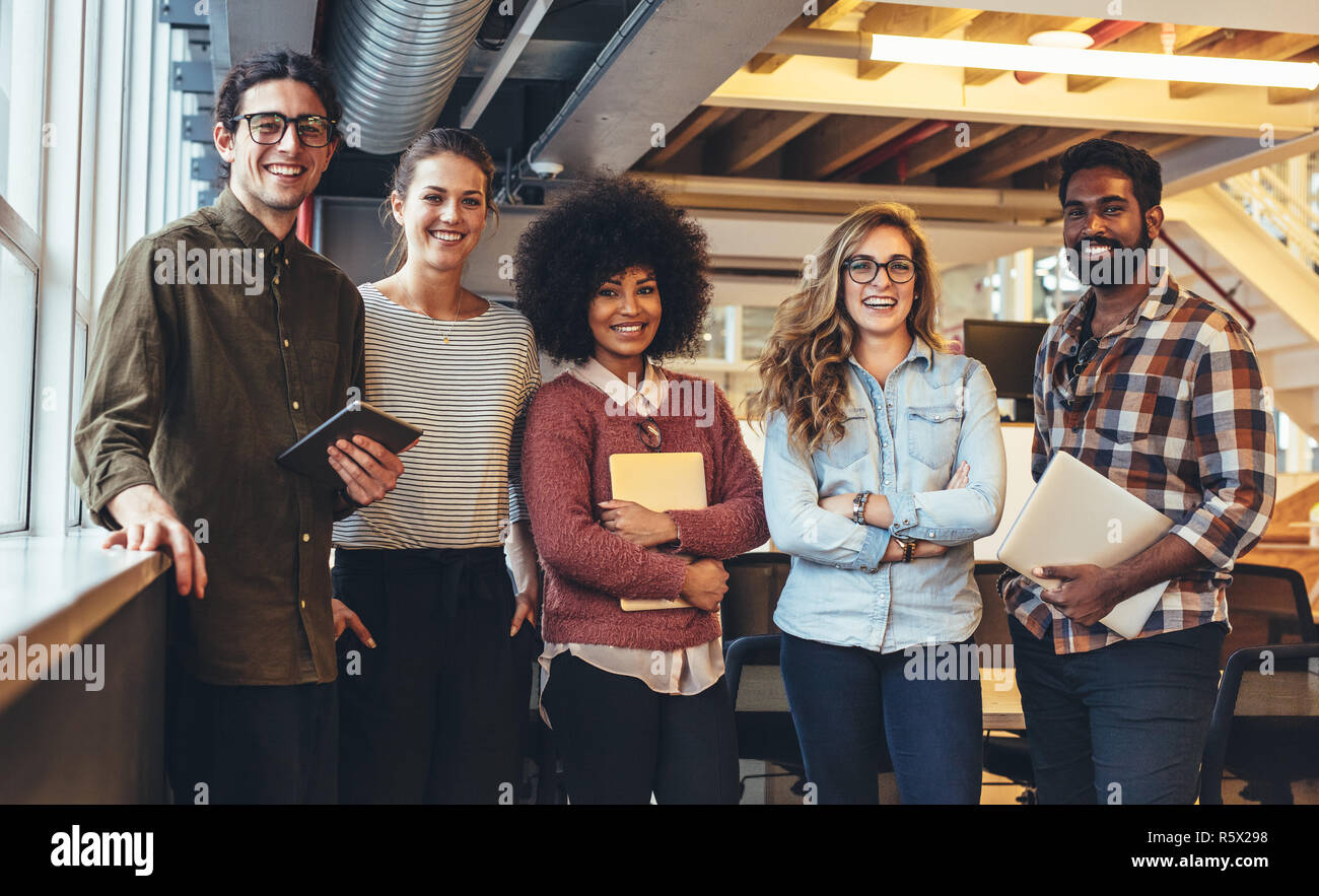 Group photo of five people from a small startup companies ...