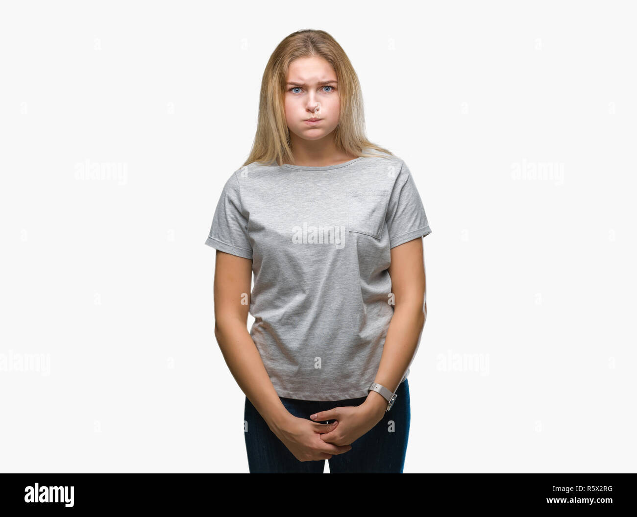 Young caucasian woman over isolated background puffing cheeks with ...