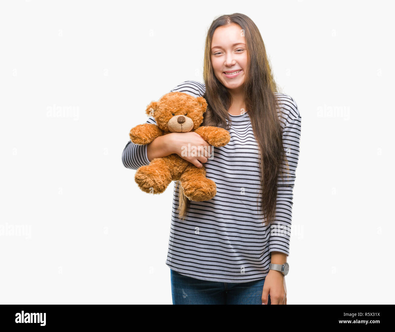 Young caucasian woman holding teddy bear over isolated background with ...